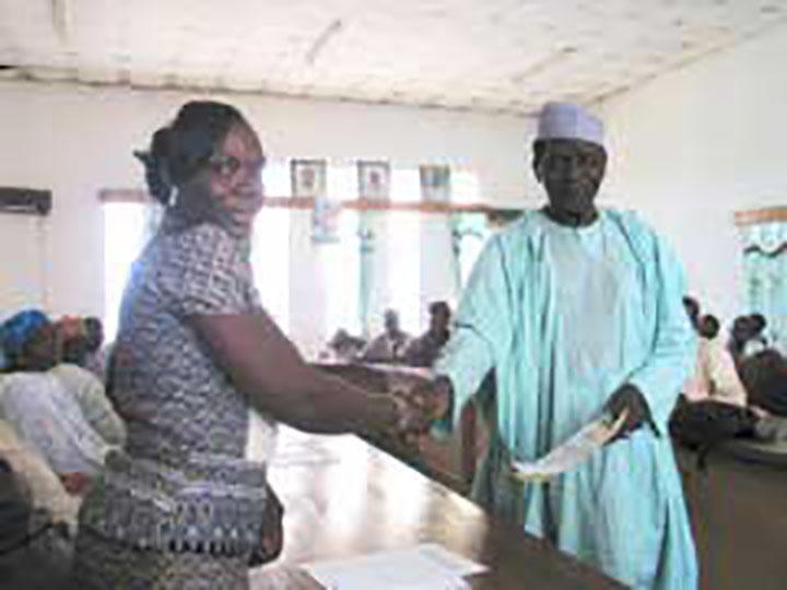 NSCGA Chair Sule Garba (right) receiving the signed MoU and Purchase ...